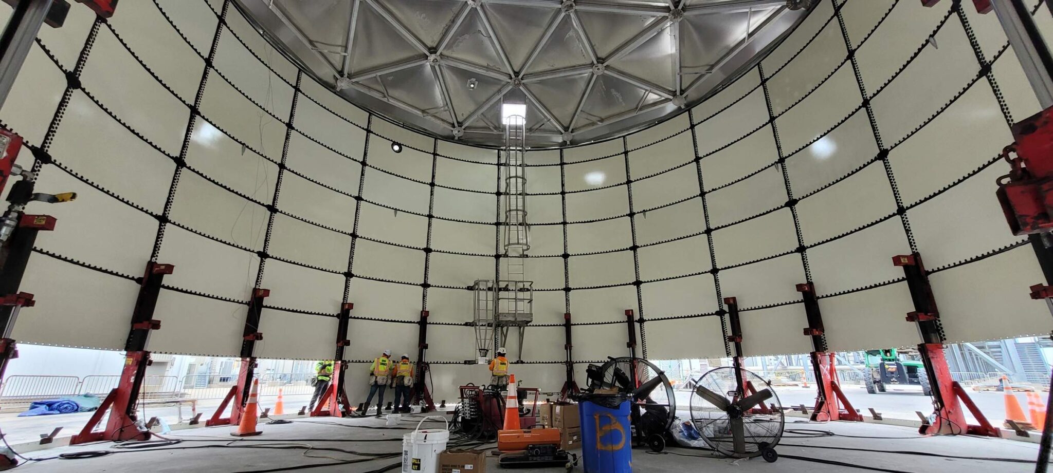 UIG Tanks Crew using jacks to lift the wall of a glass lined bolted ...